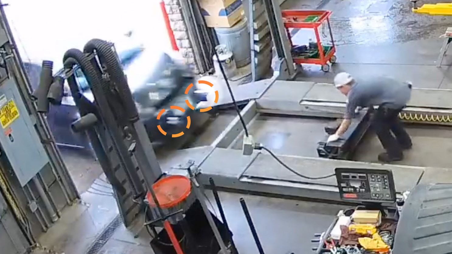 Mechanic Miraculously Survives Hit From Runaway Car Barreling Into Shop